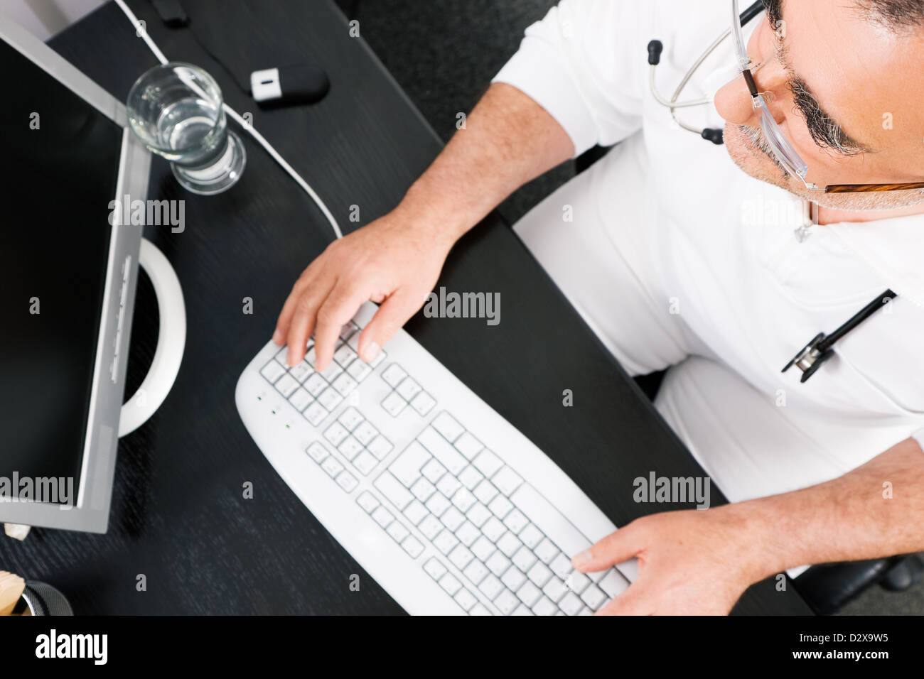Doctor working at the PC Stock Photo - Alamy