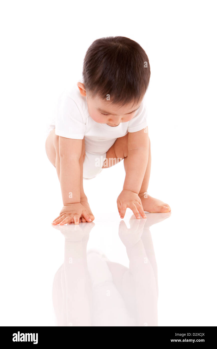 Lovely baby boy crouching Stock Photo - Alamy