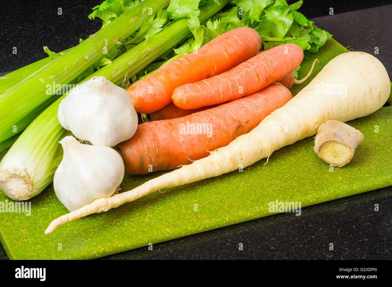 Fresh vegetables on a green cutting board ready to prepare Stock Photo ...