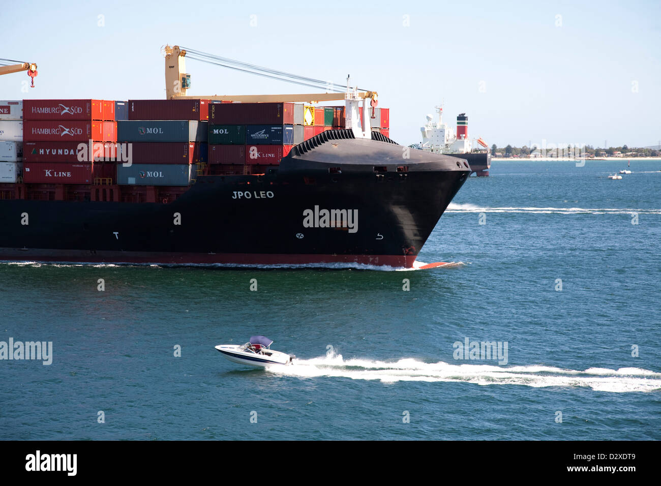 JPO LEO container ship dwarf's a passing speedboat as it arrives at ...