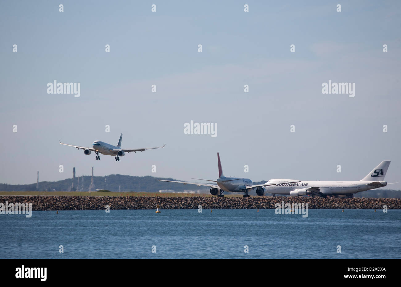 Two commercial passenger jet aircraft waiting to take off as another ...