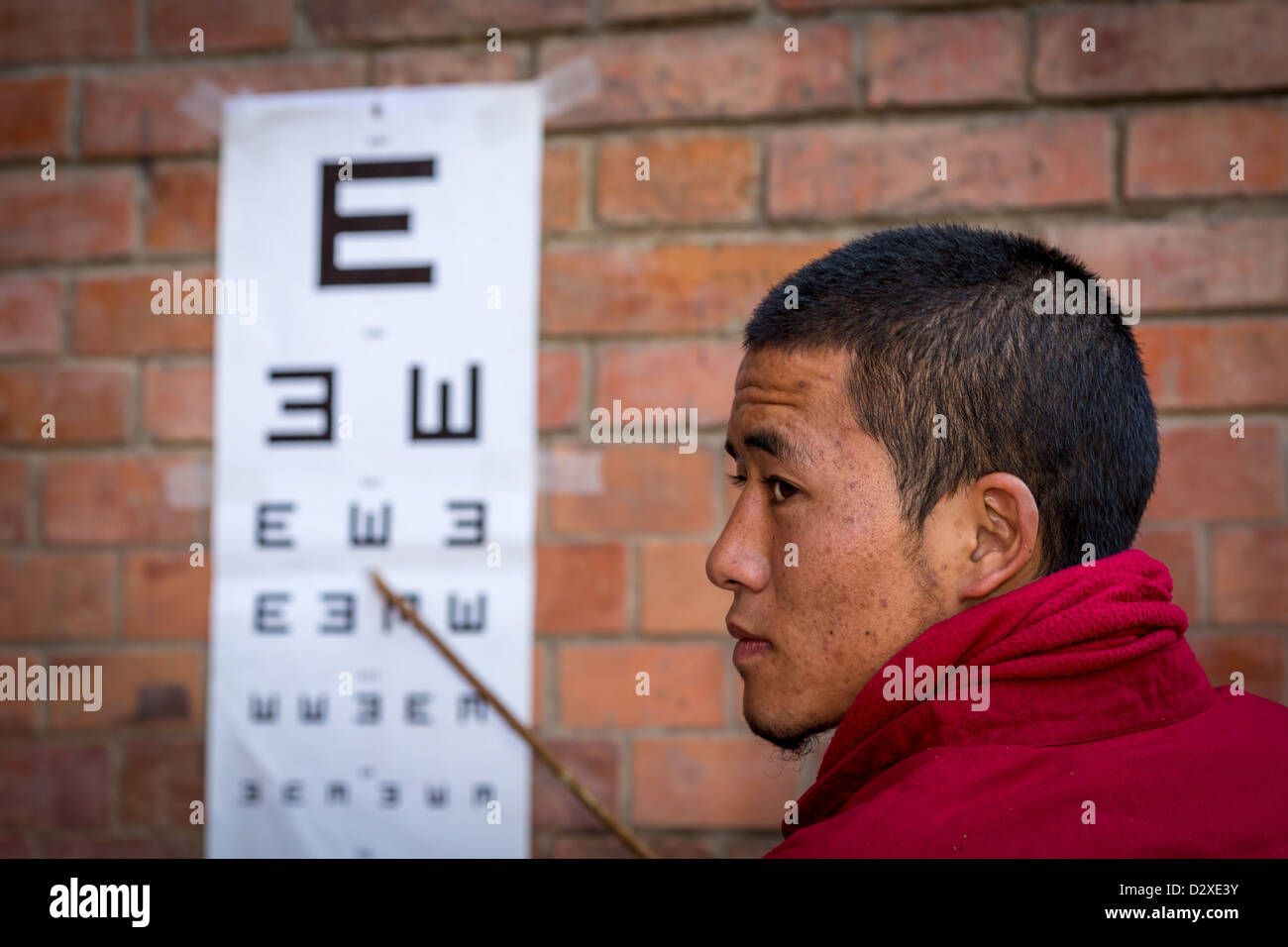 A monk from Amitabha monastery caring out a charity vision test for ...