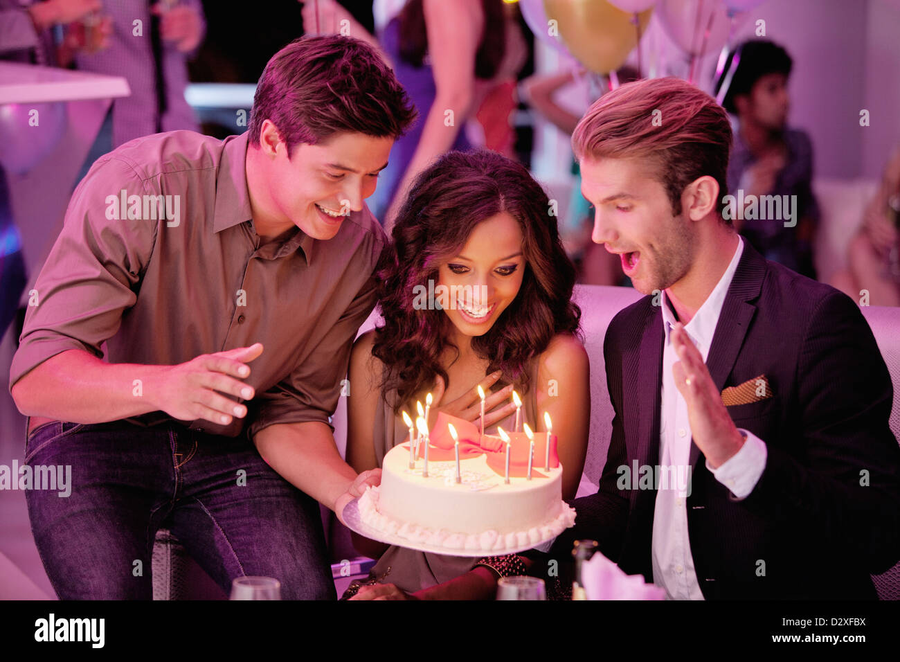 Friends with birthday cake in nightclub Stock Photo - Alamy