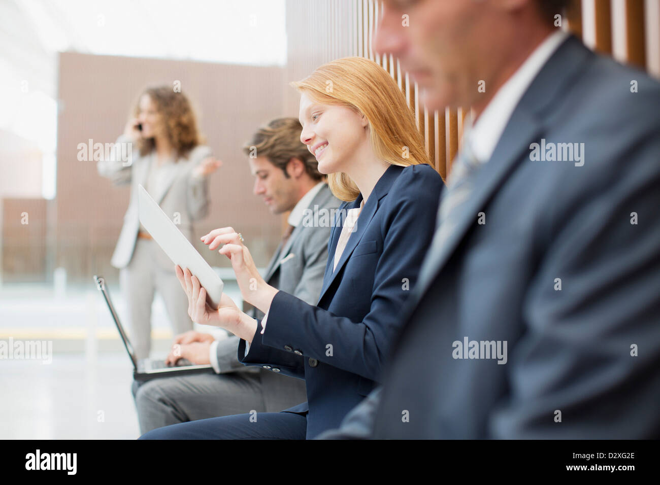 Business people using laptop and digital tablet Stock Photo - Alamy