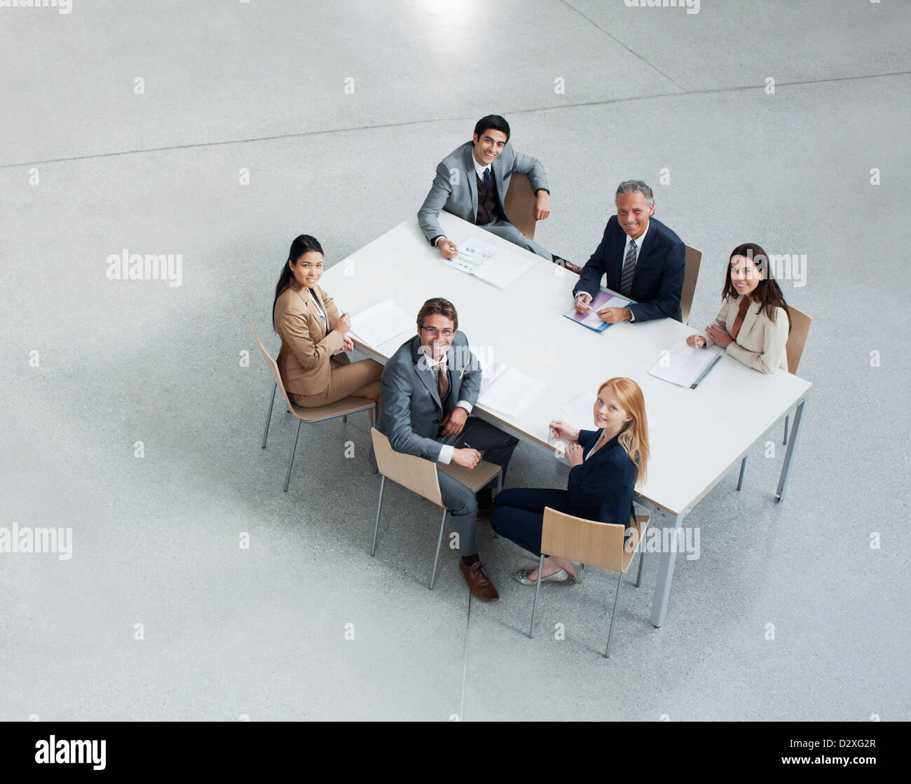 Portrait of smiling business people meeting at table Stock Photo - Alamy