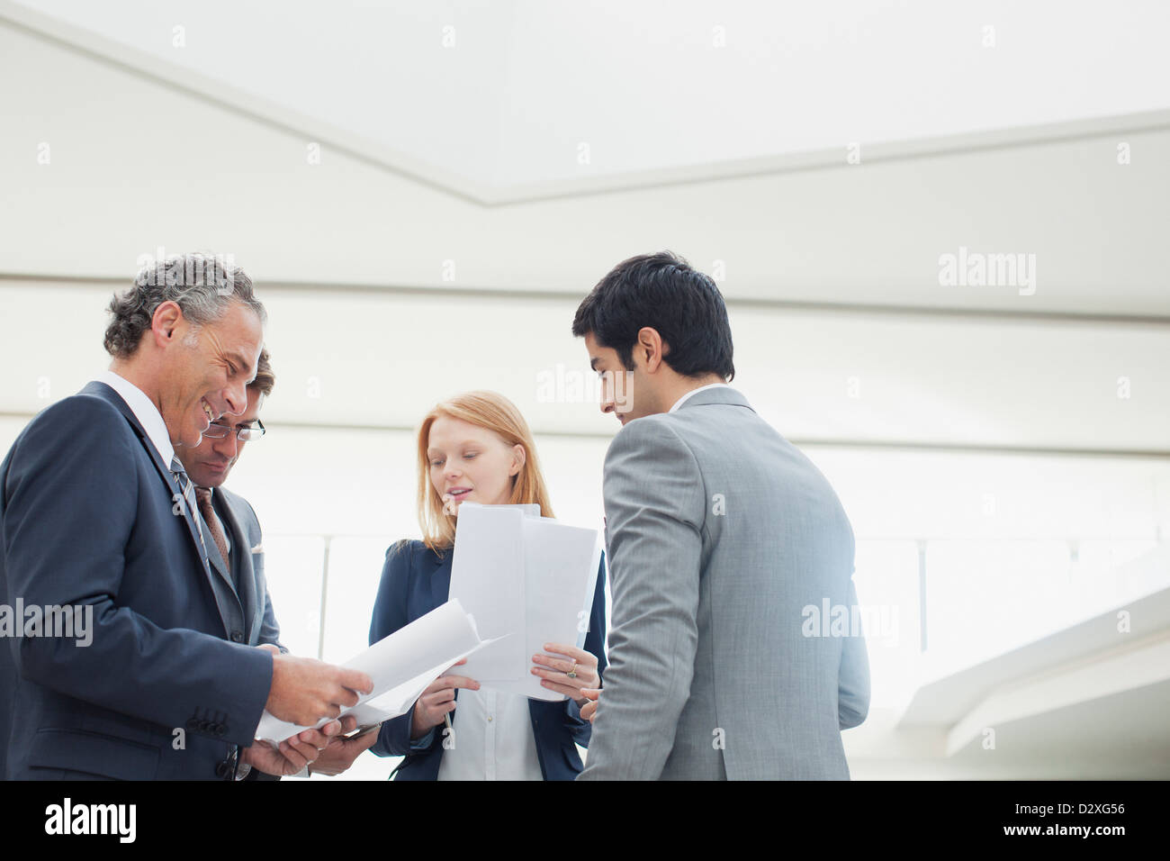 Business people discussing paperwork Stock Photo - Alamy