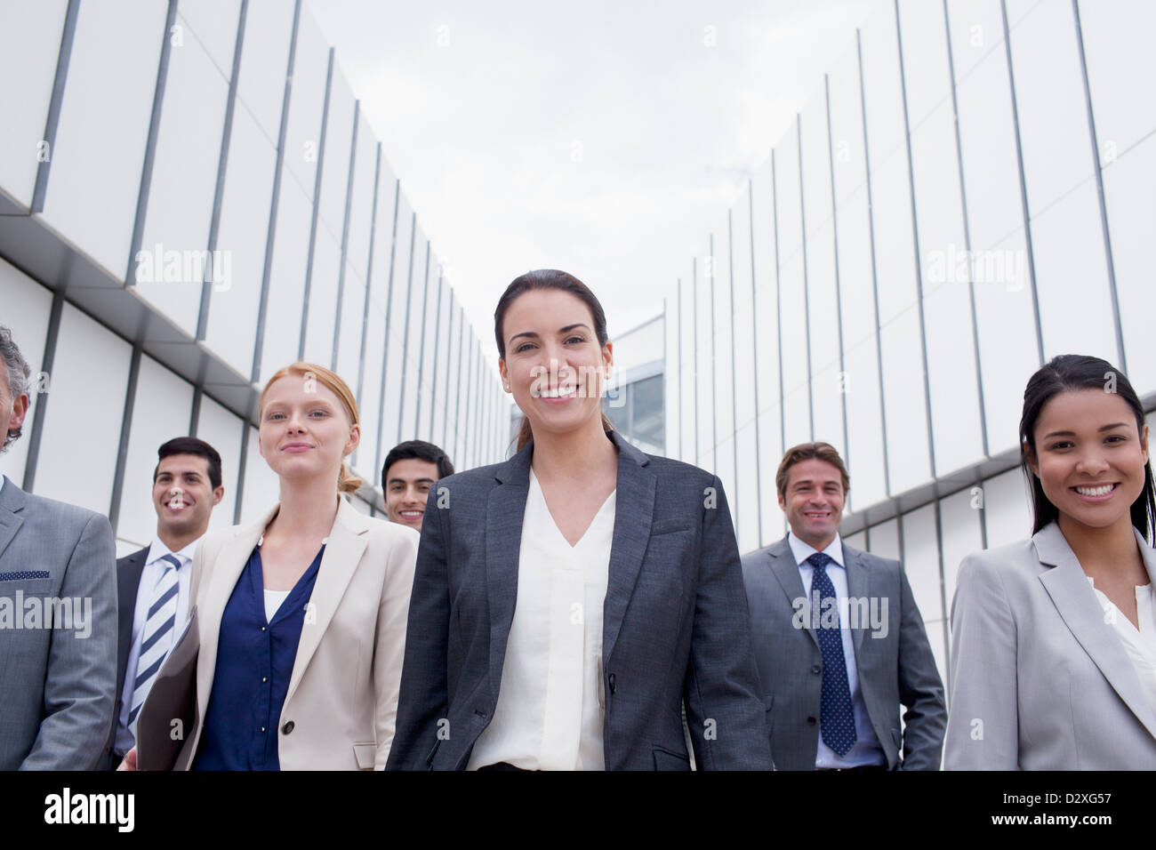 Portrait of smiling business people walking Stock Photo - Alamy