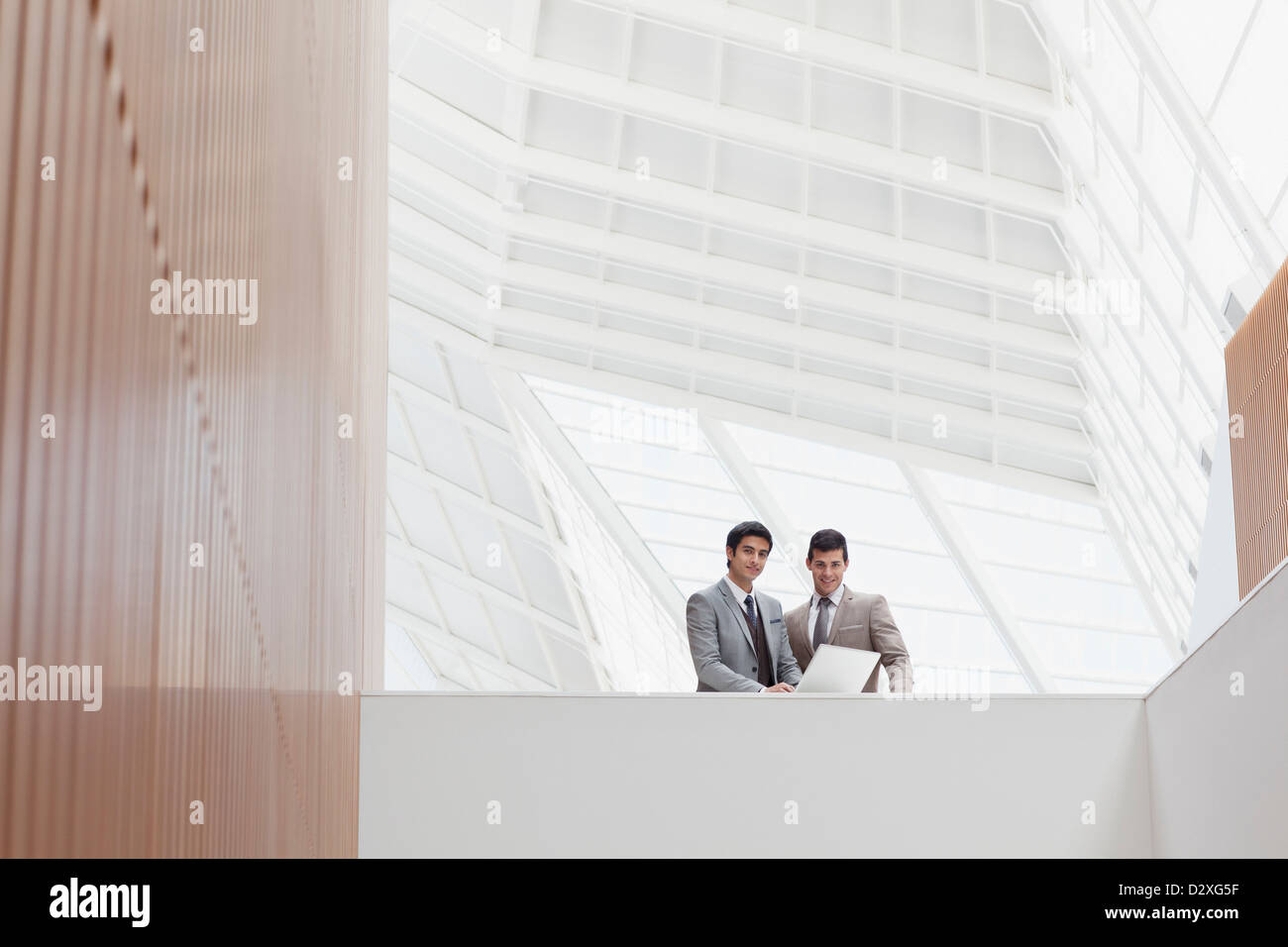 Two young businessmen working together in co working space hi-res stock ...