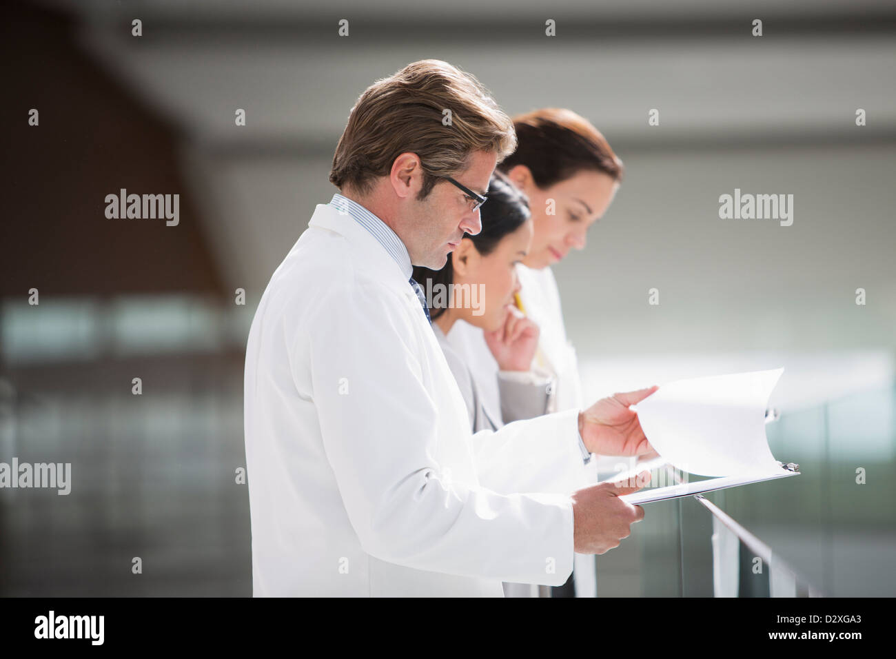Reviewing paperwork lab coat hi-res stock photography and images - Alamy