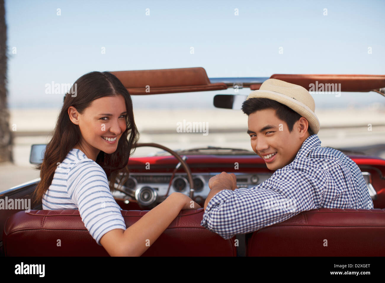 Smiling couple sitting in convertible Stock Photo - Alamy