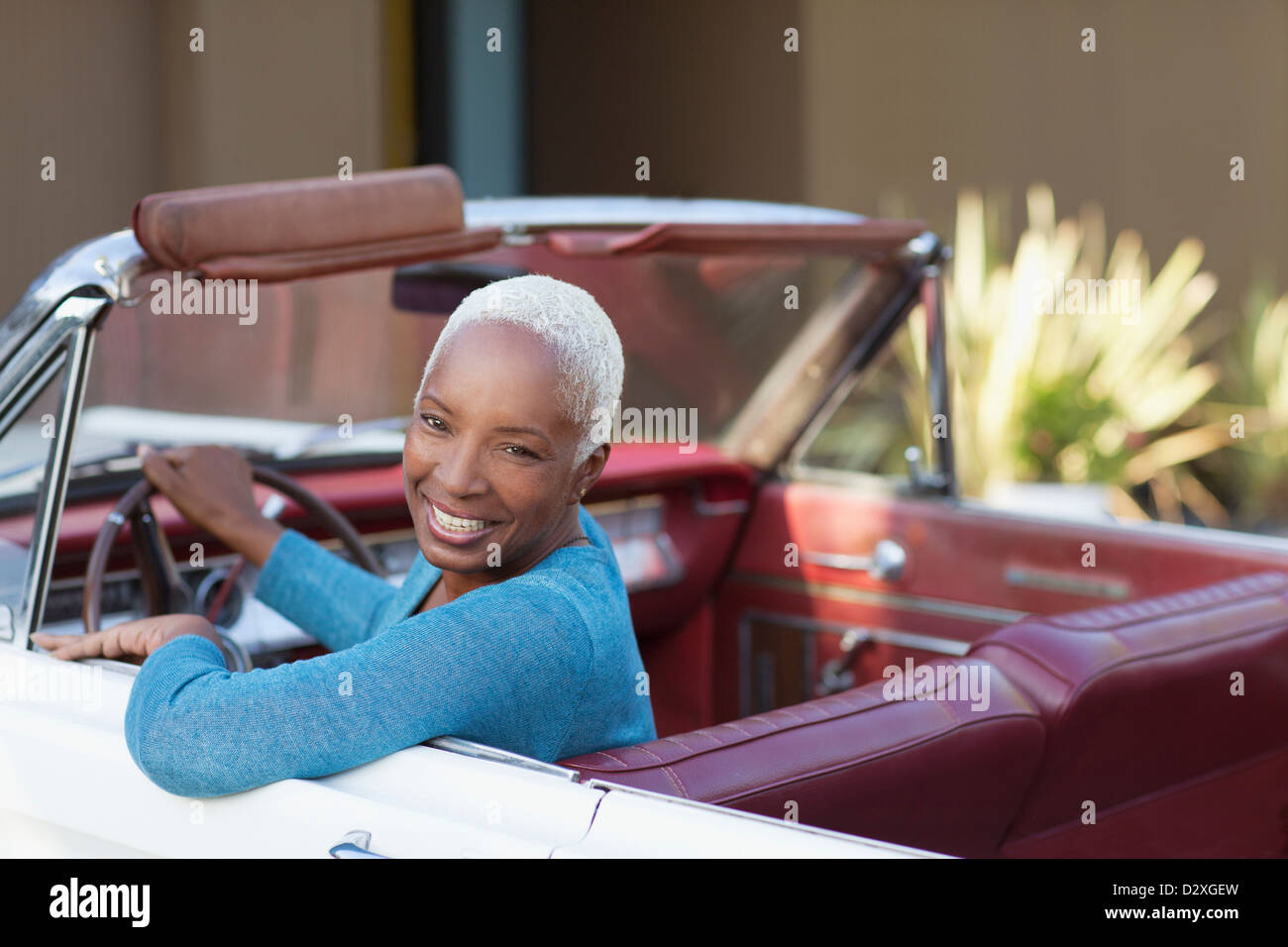 Smiling older woman driving convertible Stock Photo - Alamy