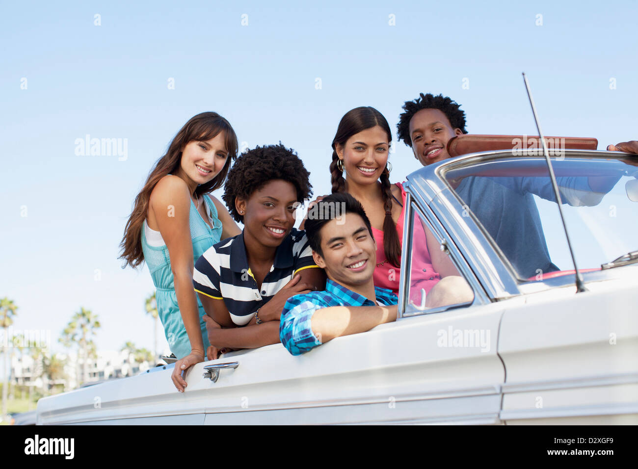 Smiling friends sitting in convertible Stock Photo - Alamy