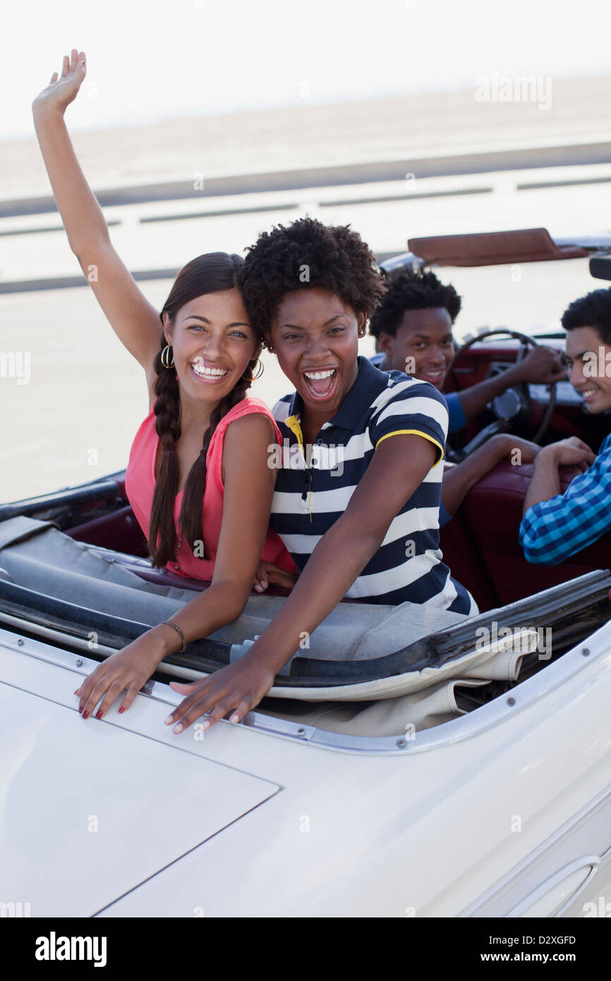 Smiling women cheering in convertible Stock Photo - Alamy
