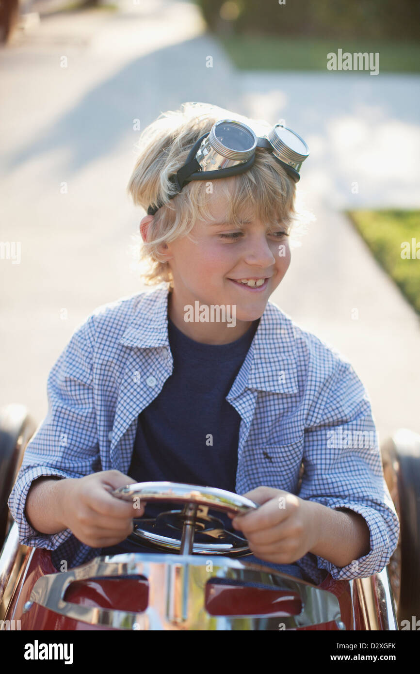 Smiling boy playing in go cart Stock Photo - Alamy