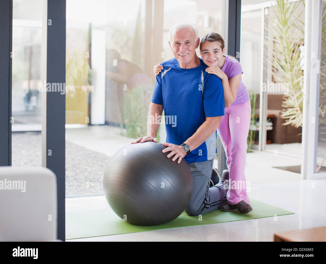Girl hugging grandfather on exercise ball Stock Photo - Alamy