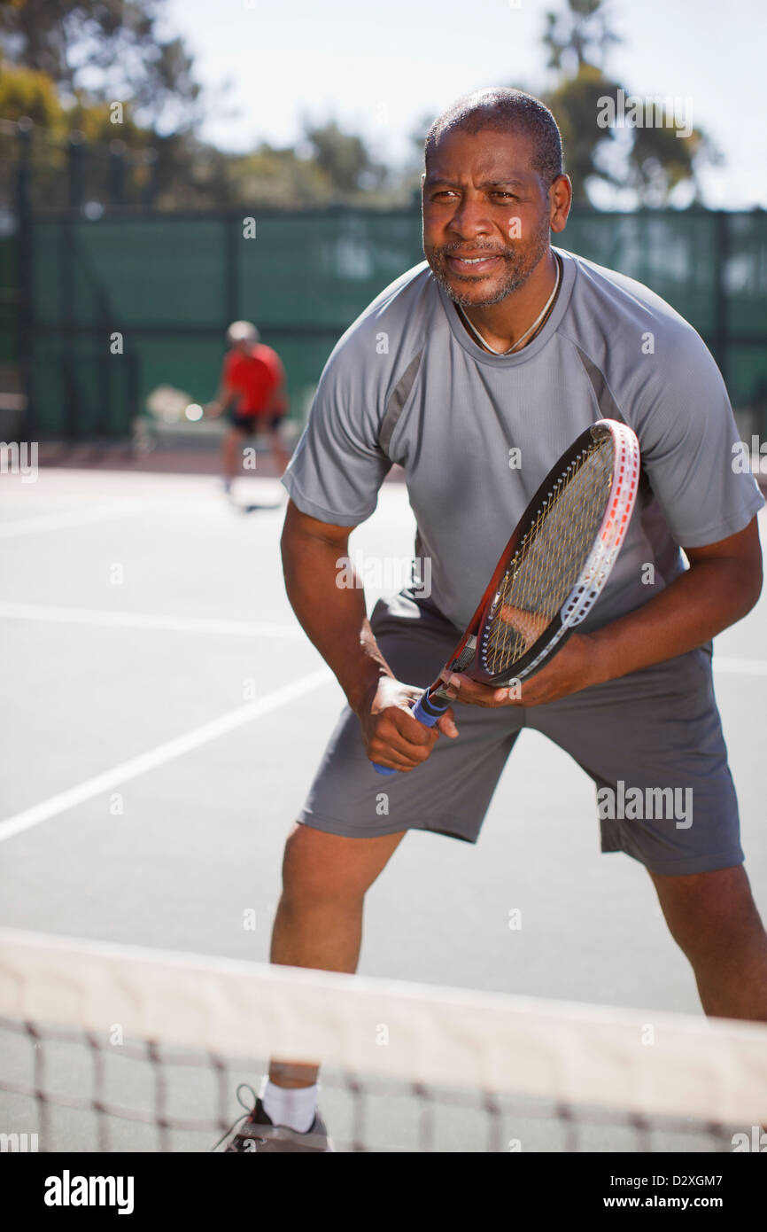 Older man playing tennis on court Stock Photo - Alamy