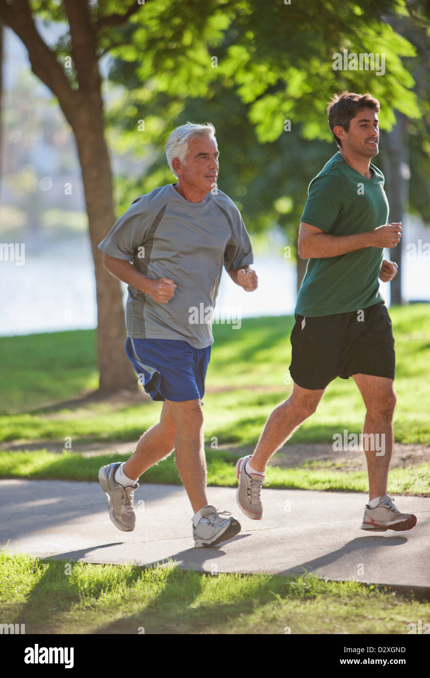 Men jogging together in park Stock Photo - Alamy