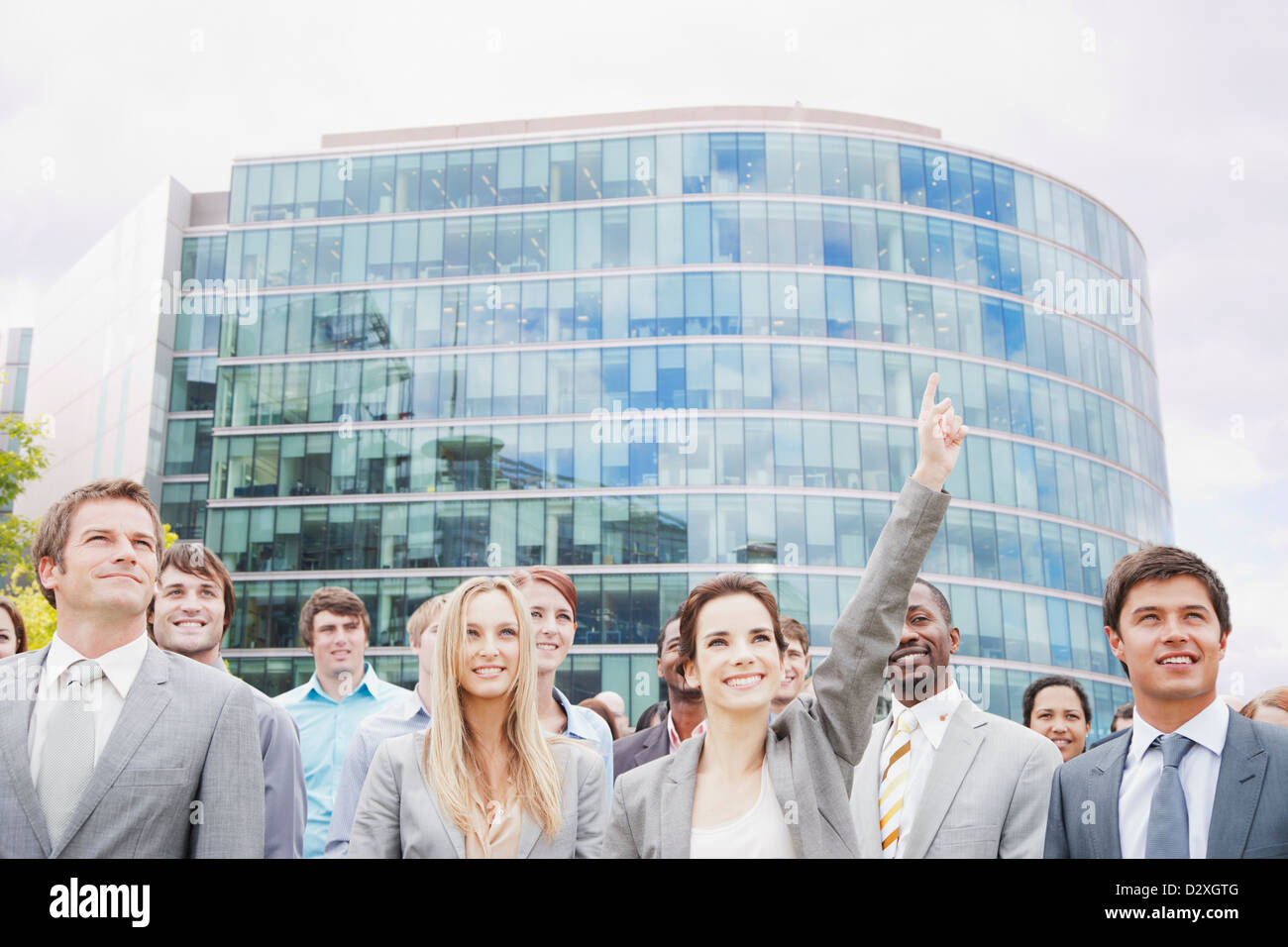 Crowd of smiling business people in front of building Stock Photo - Alamy