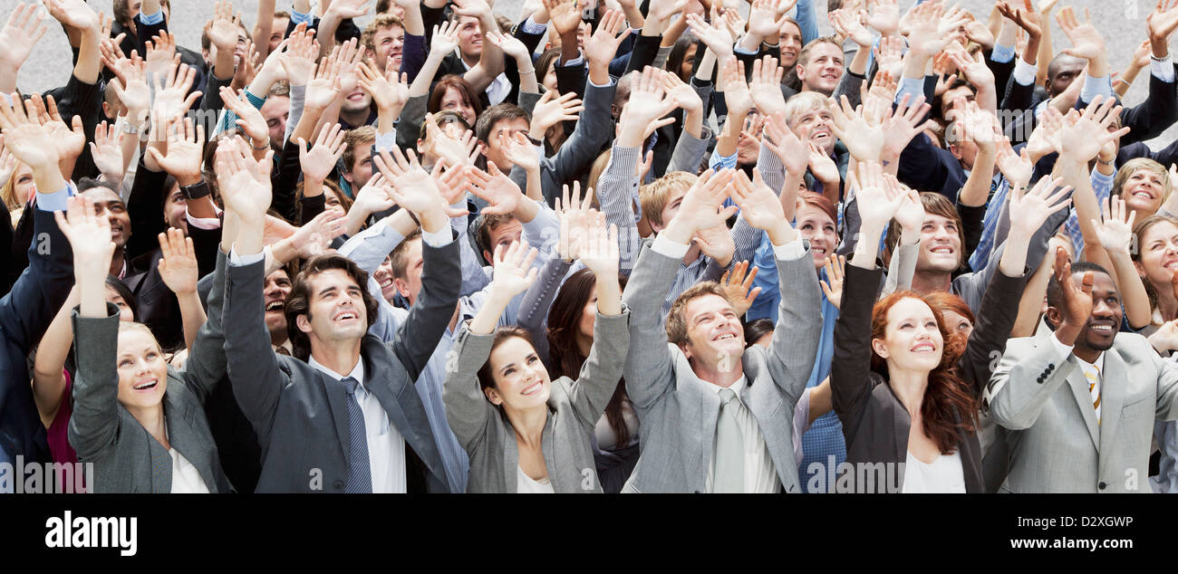 Crowd of business people cheering with arms raised Stock Photo - Alamy