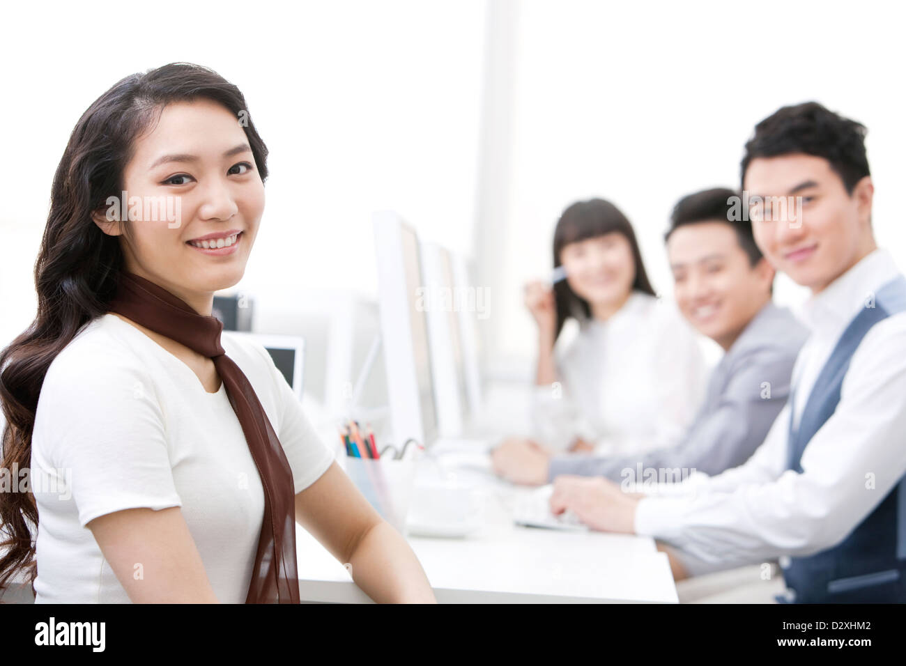 Cheerful white collar workers using computers in office Stock Photo - Alamy