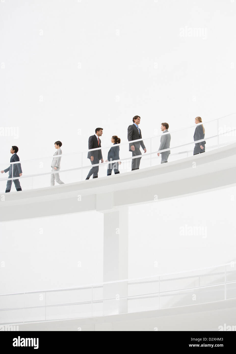 Business people walking along elevated walkway Stock Photo - Alamy