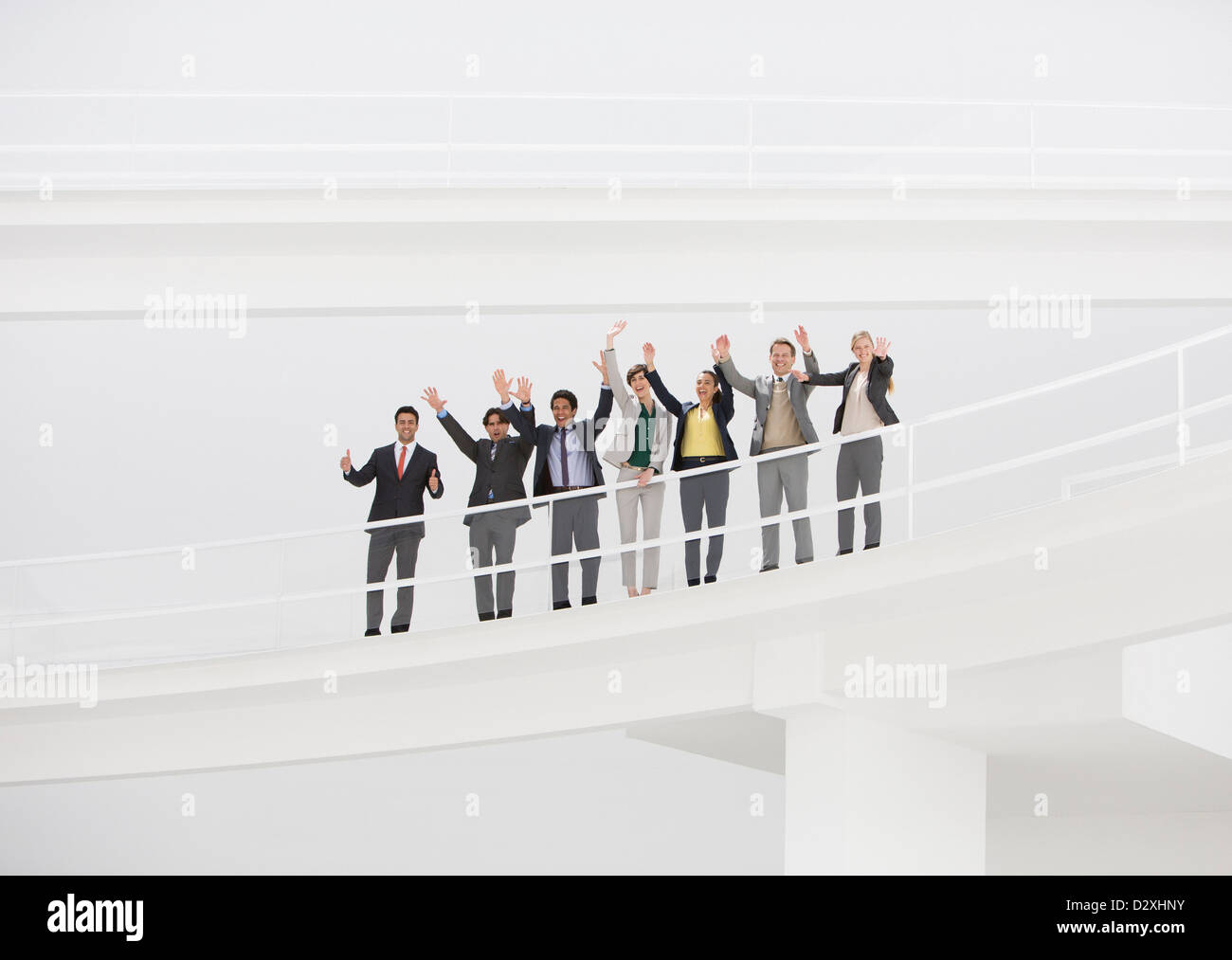 Portrait of cheering business people on elevated walkway Stock Photo ...