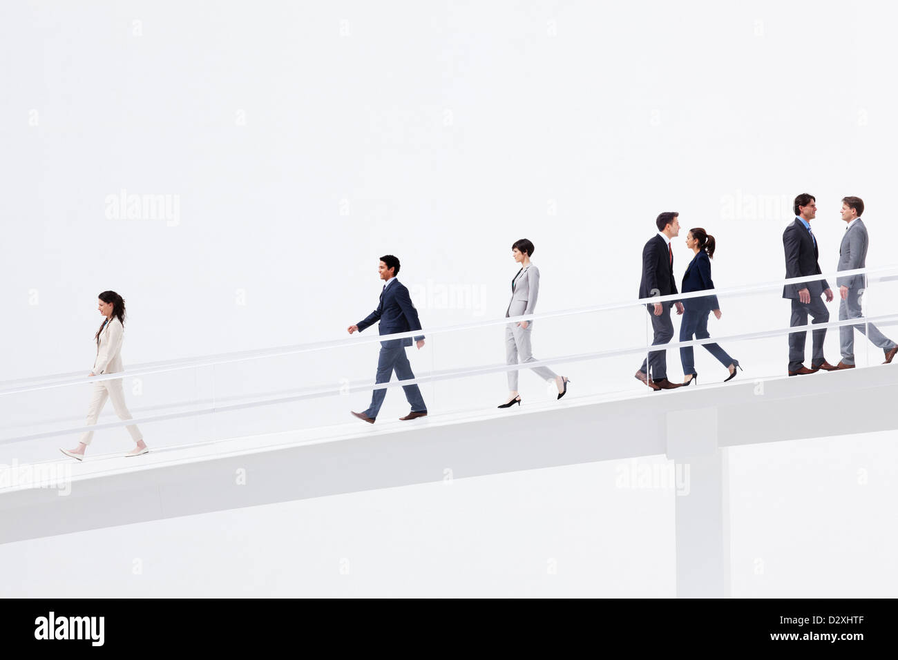 Business people walking down elevated walkway Stock Photo - Alamy