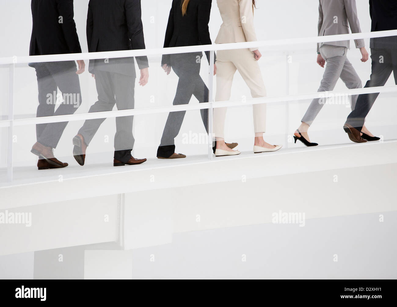 Business people ascending elevated walkway Stock Photo - Alamy
