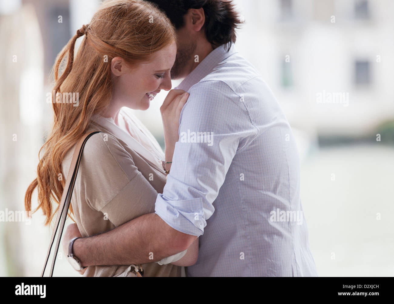 Smiling couple hugging Stock Photo - Alamy