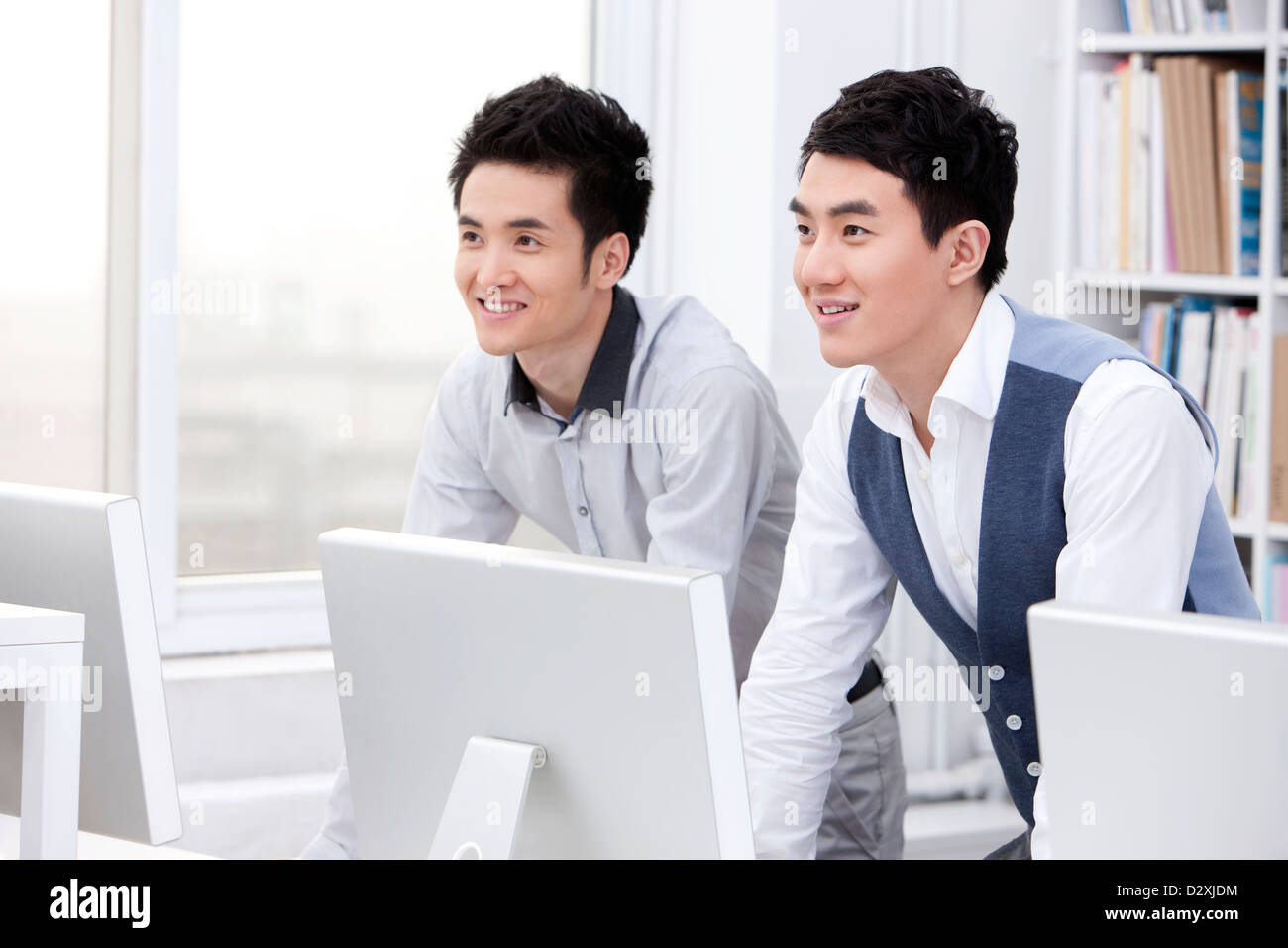 Cheerful office workers using hi-res stock photography and images - Alamy