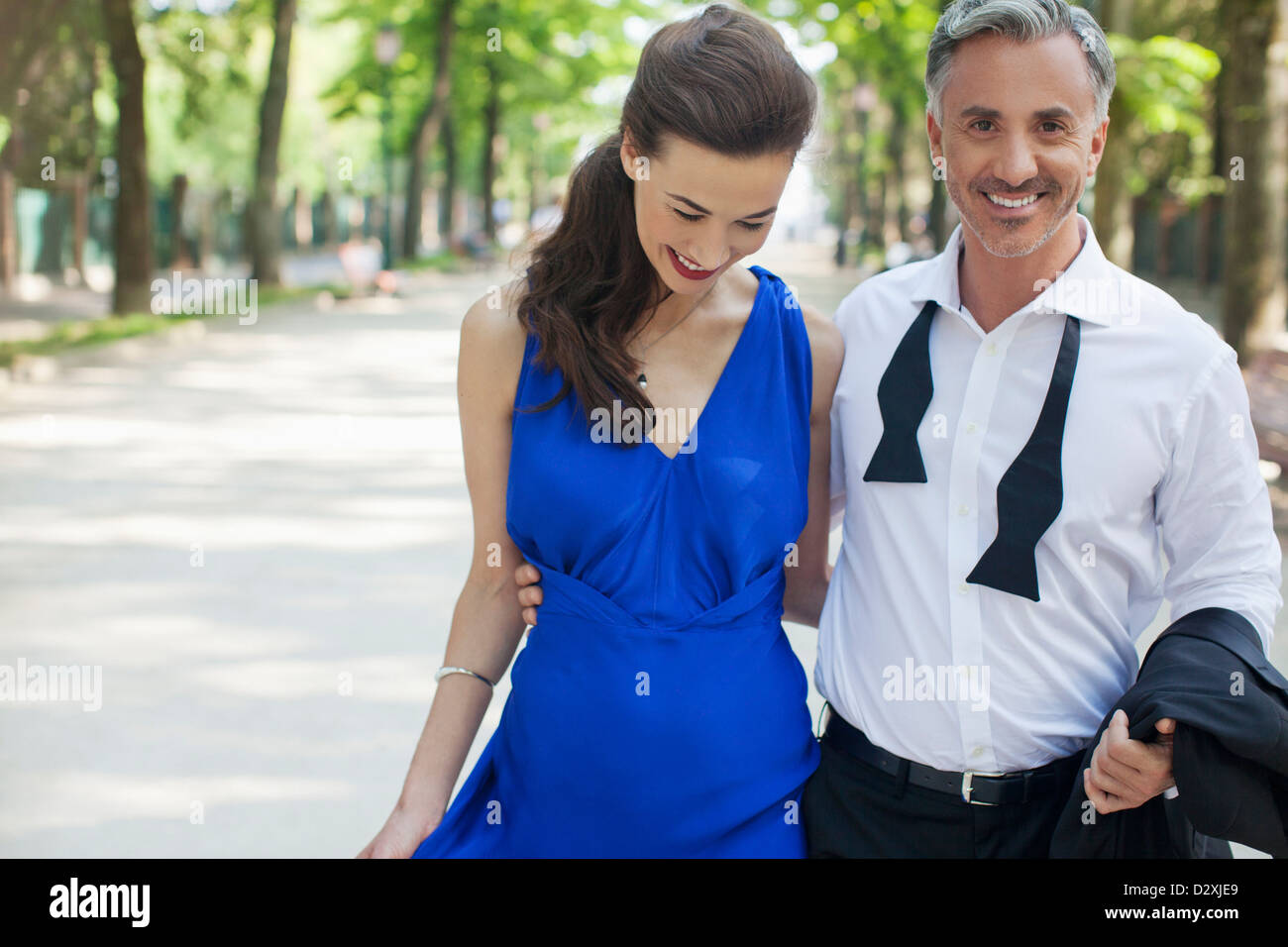 Smiling well-dressed couple in park Stock Photo - Alamy