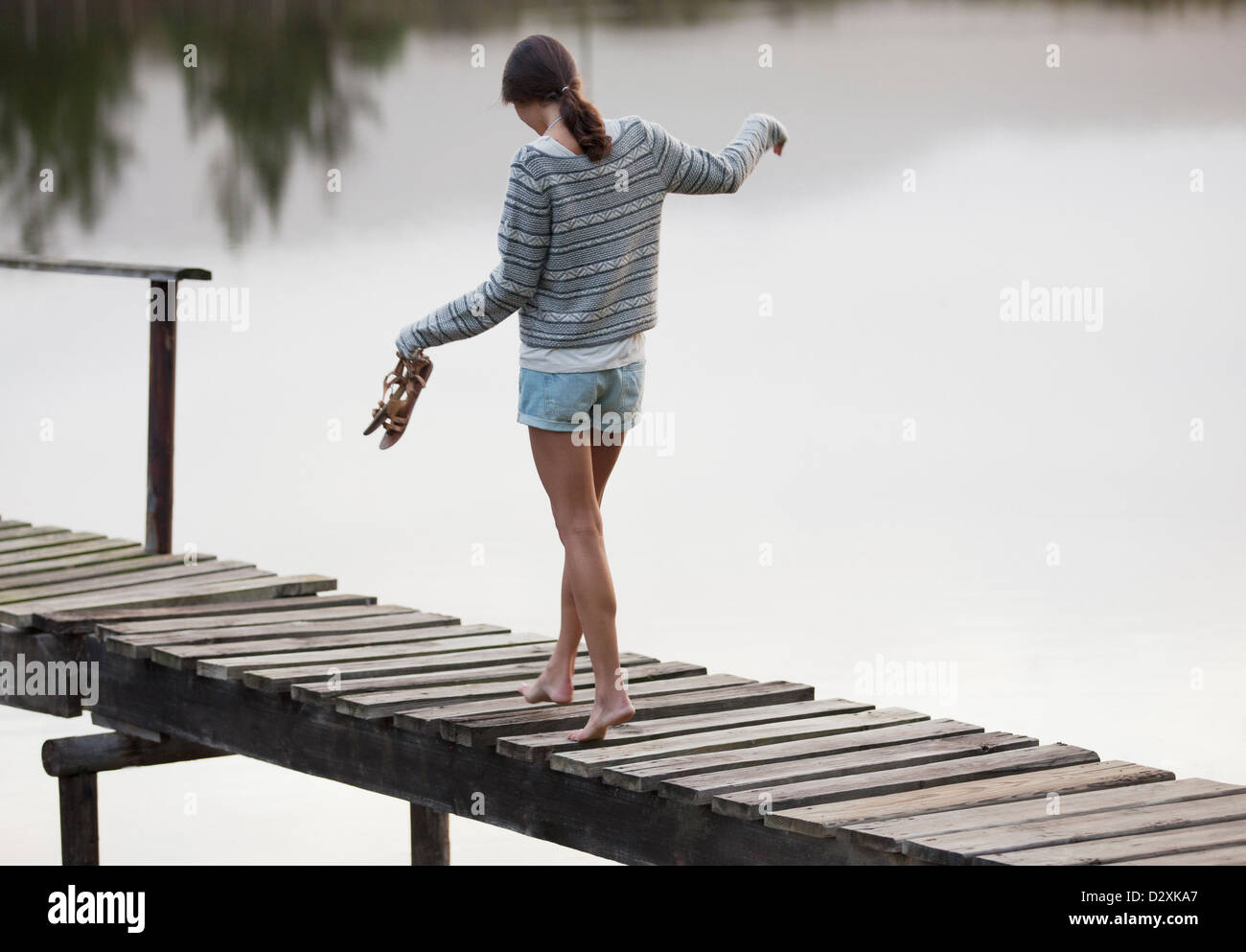 Female person walking lake pier hi-res stock photography and images - Alamy