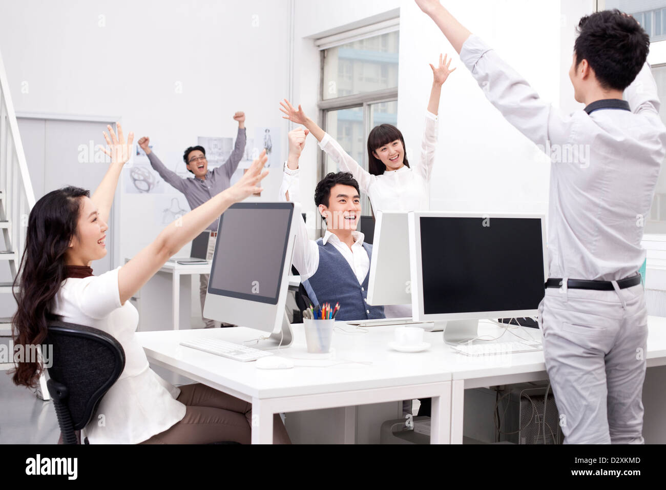 Joyful office workers celebrating Stock Photo - Alamy