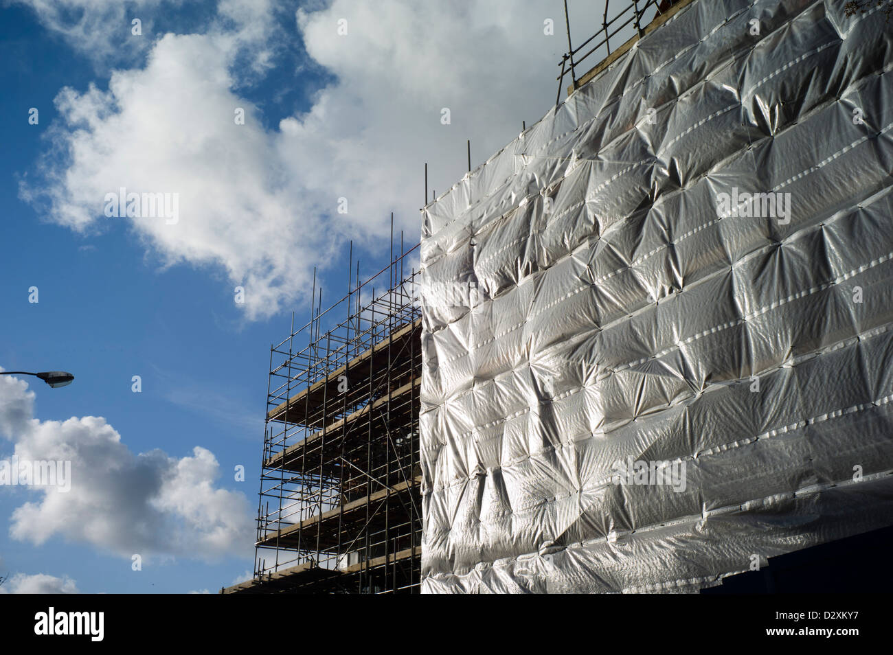 partly wrapped scaffolded building Stock Photo - Alamy