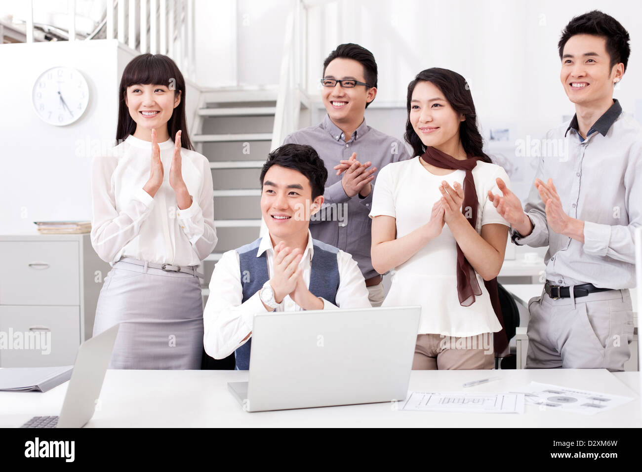 Happy office workers clapping in studio Stock Photo - Alamy