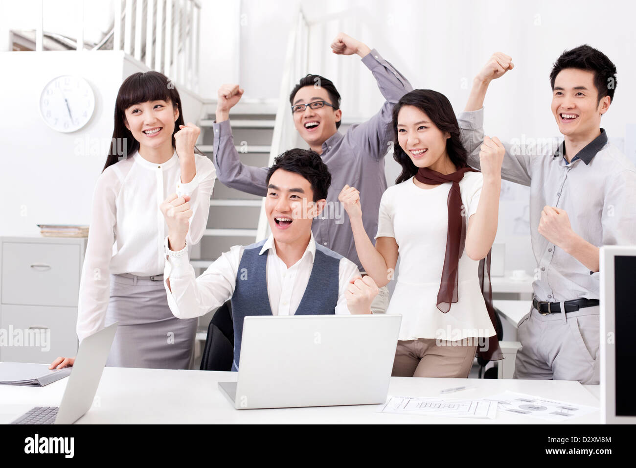 Happy office workers punching the air in studio Stock Photo - Alamy