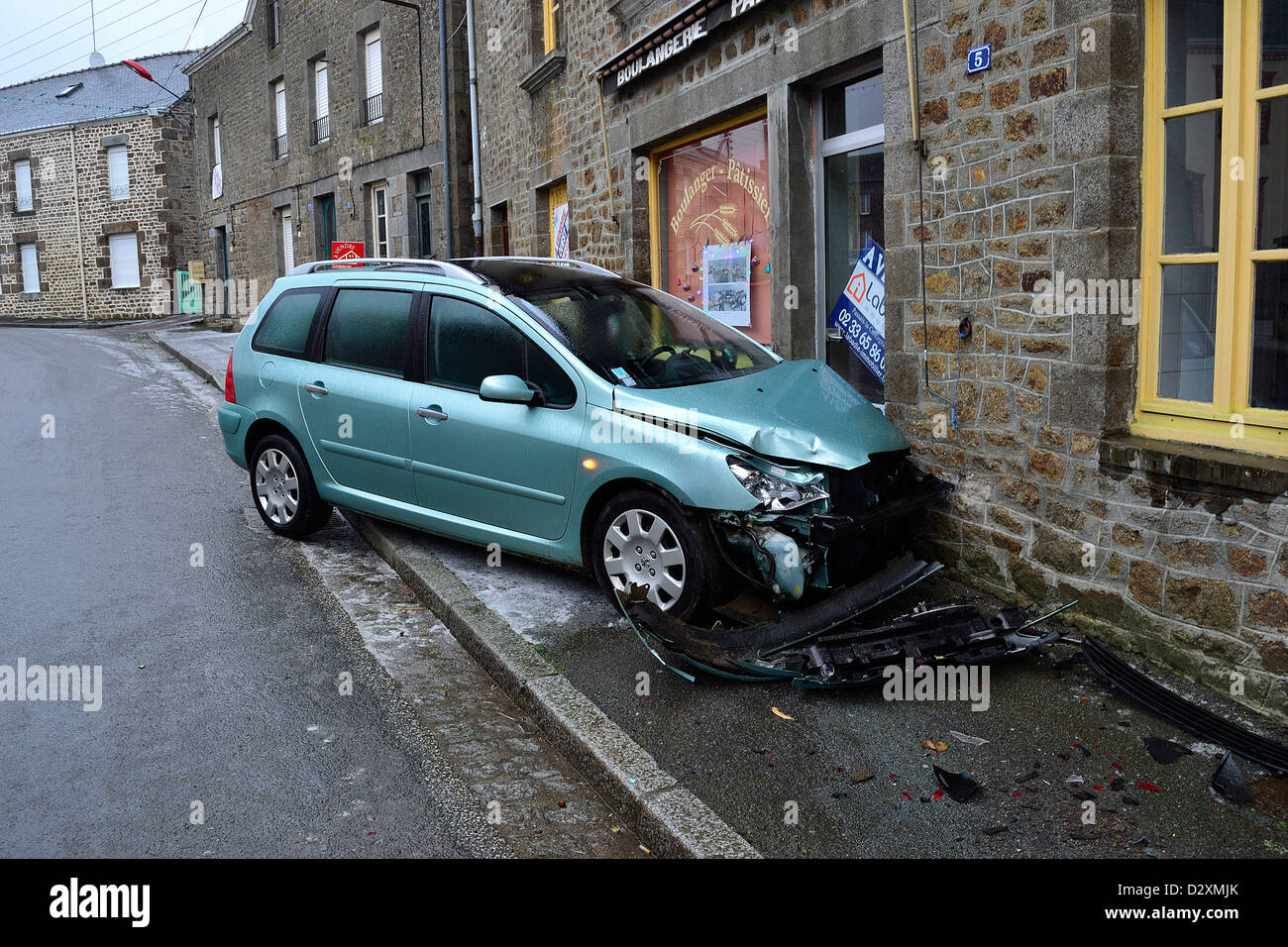 Skid of a car on the icy road, the car finish its race on a house of ...