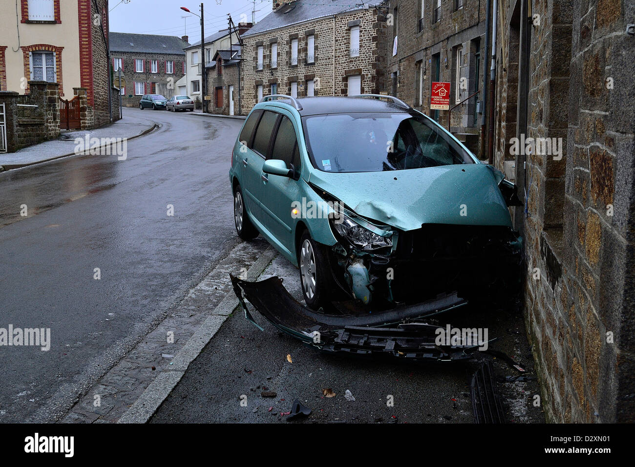 Skid of a car on the icy road, the car finish its race on a house of ...
