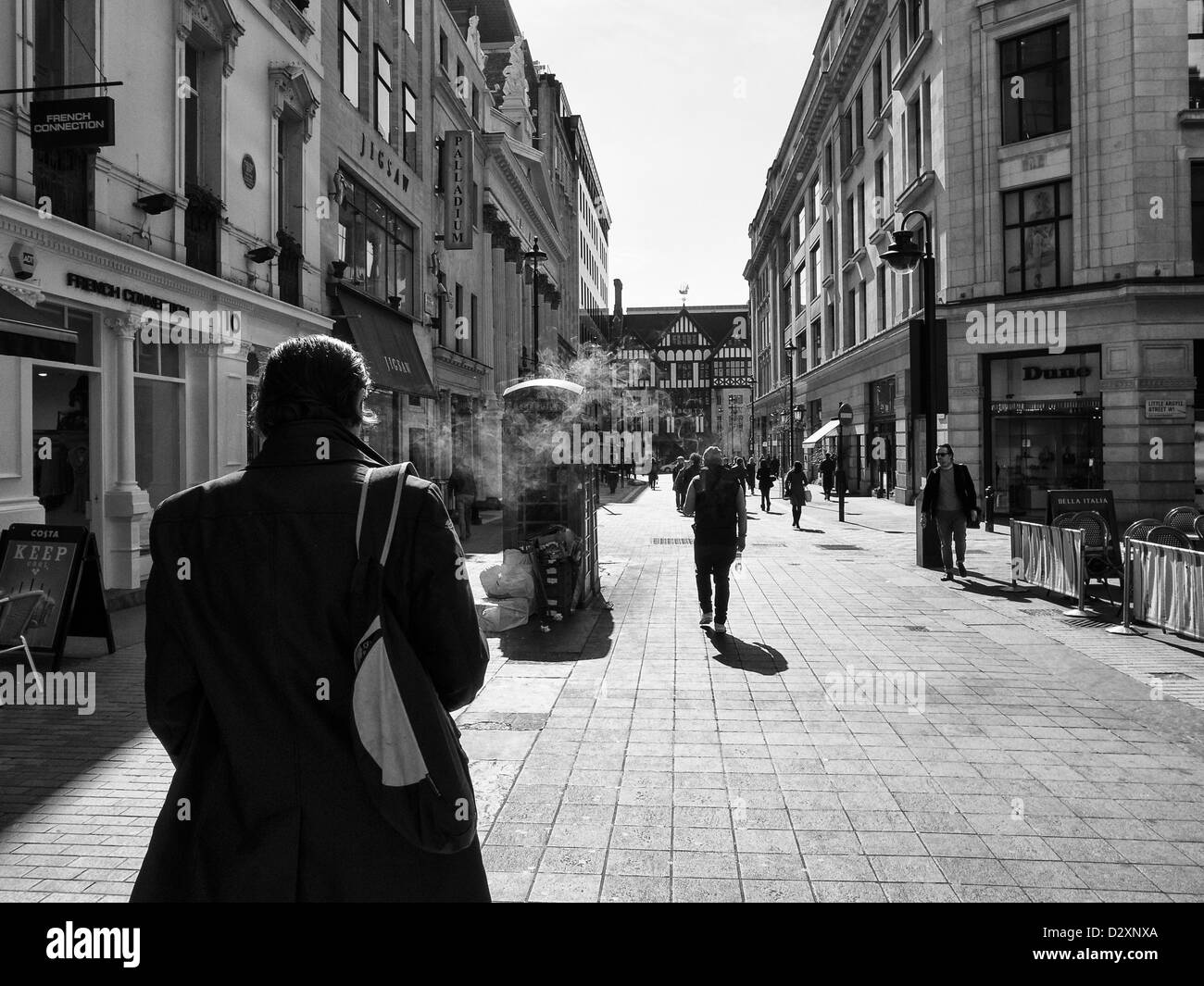 Smoking man walking street in early sun Stock Photo - Alamy