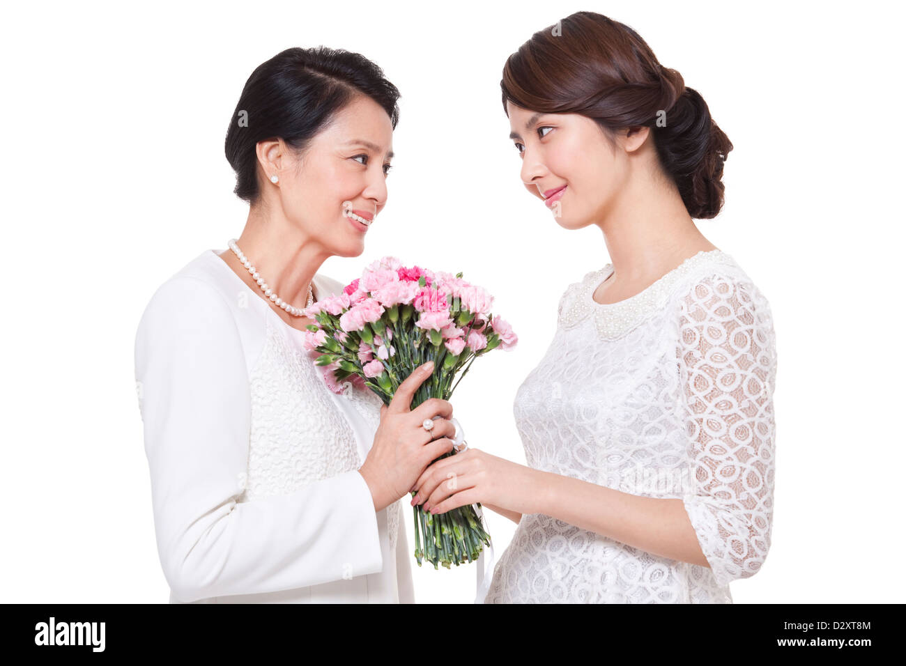 Happy daughter giving flowers to mother Stock Photo - Alamy