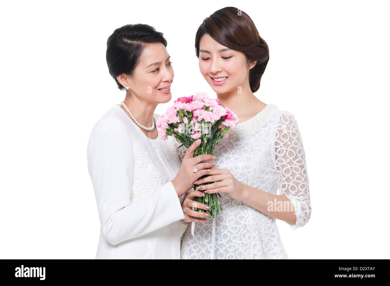 Happy daughter giving flowers to mother Stock Photo - Alamy