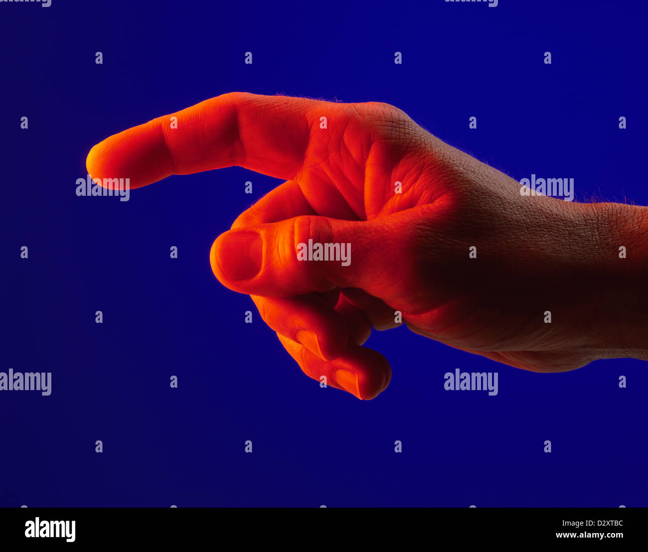 Pointing hand, red light, blue background Stock Photo - Alamy