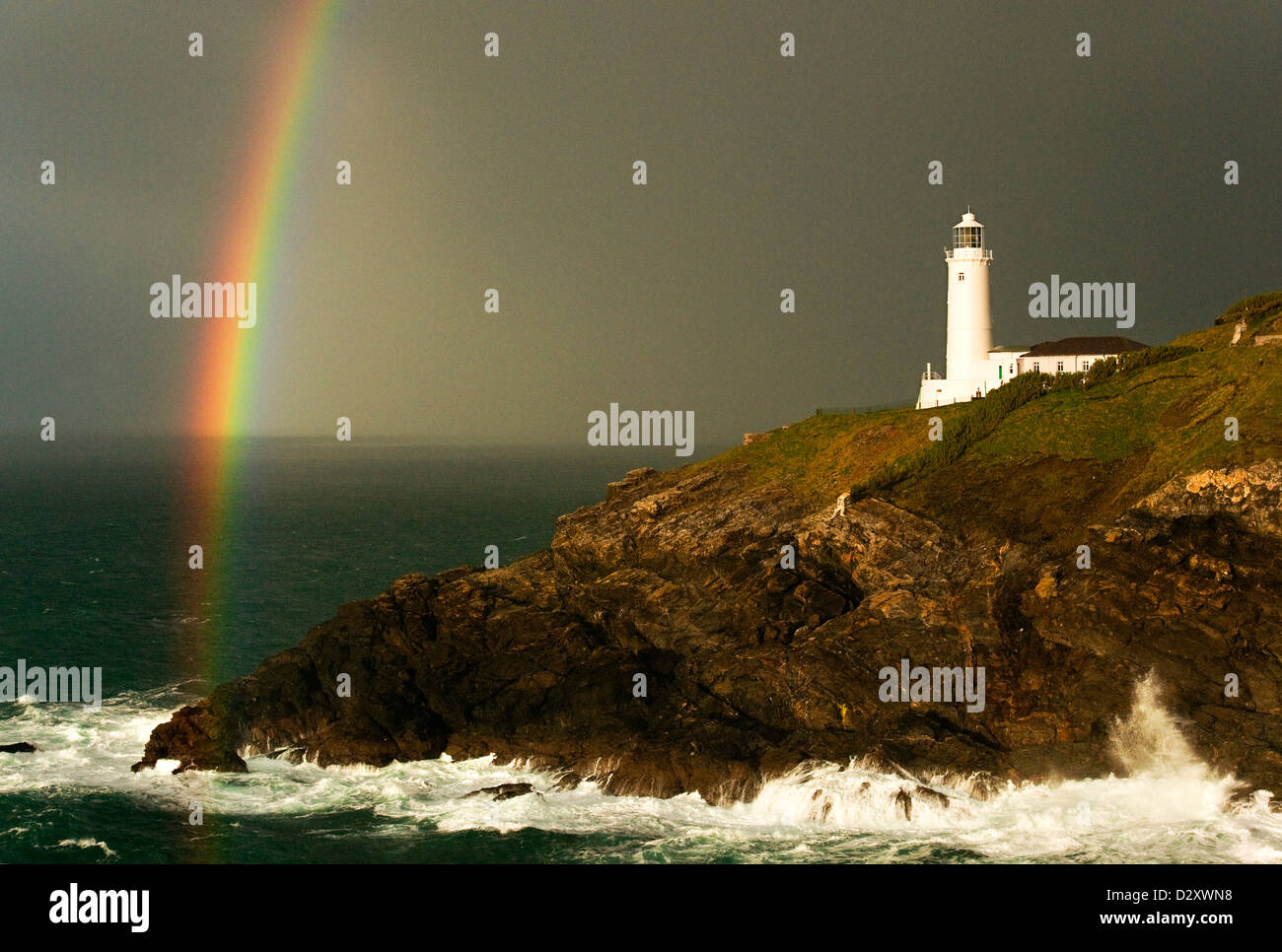 A rainbow over Trevose Head Lighthouse on a stormy day with a choppy ...