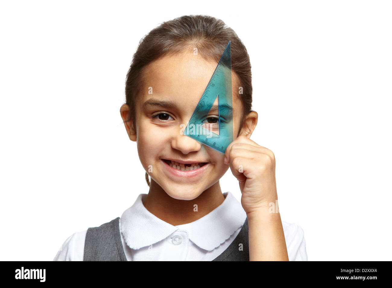 8 year old school girl with blue set square over her eyes on white ...