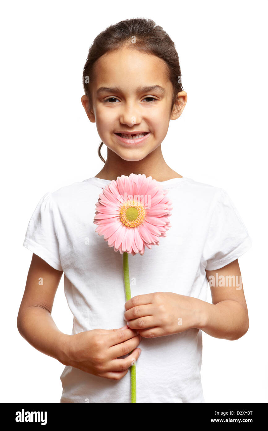 8 year old girl smiling with pink flower on white background Stock ...