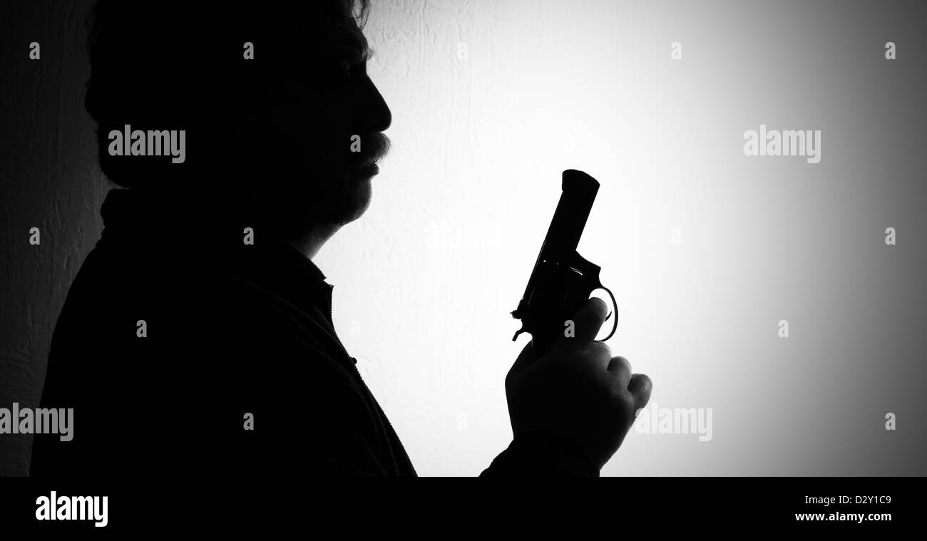 shiluette of man with a revolver, black white Stock Photo - Alamy