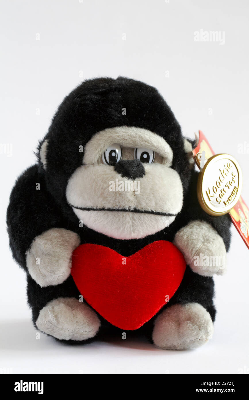 Chimp holding red heart soft cuddly toy hi-res stock photography and ...