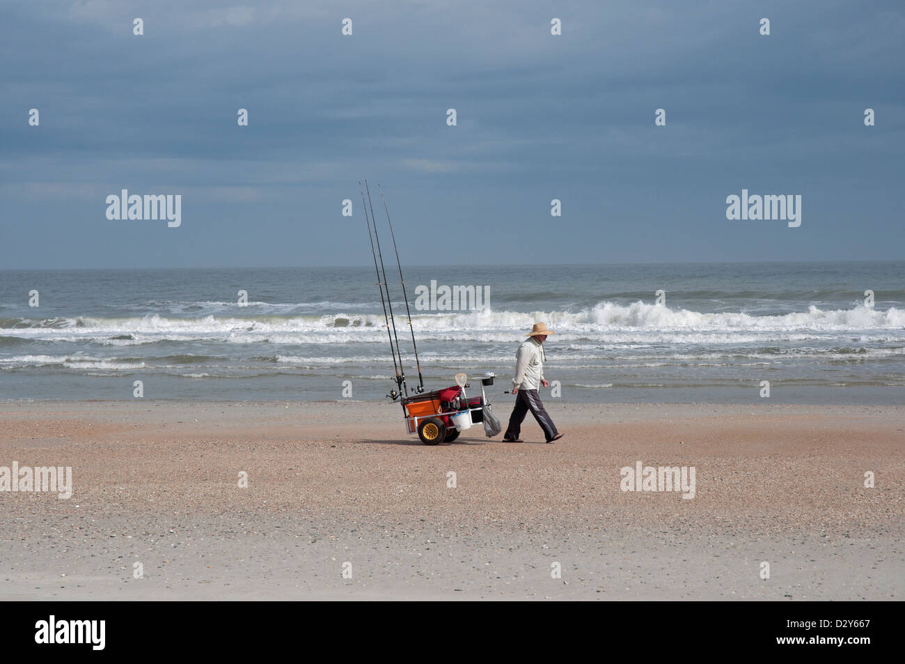 Surf fisherman walks the beach at Little Talbot Island State Park along ...