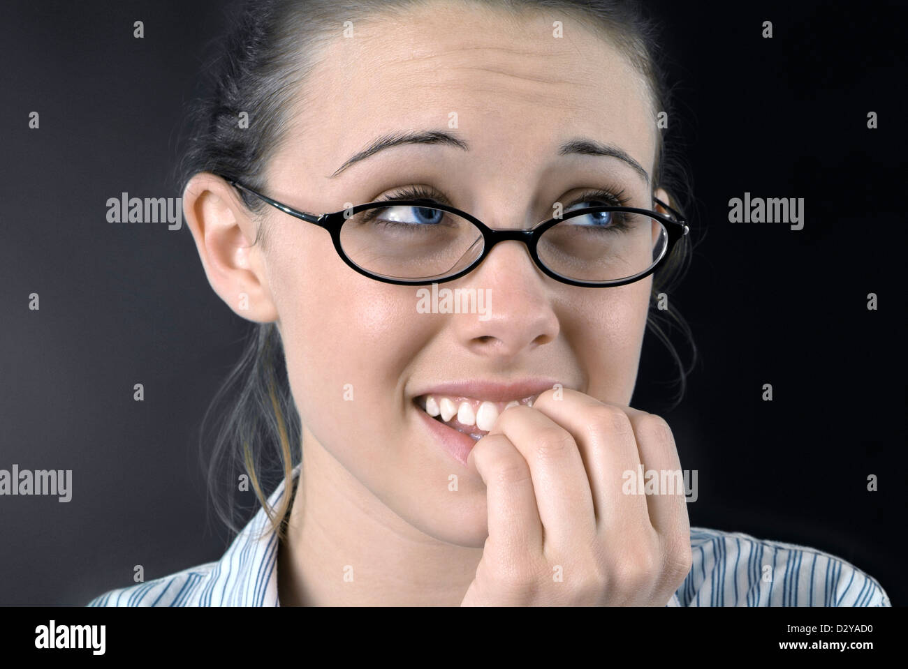 Young woman biting nails, a nervous reaction to a mistake Stock Photo ...