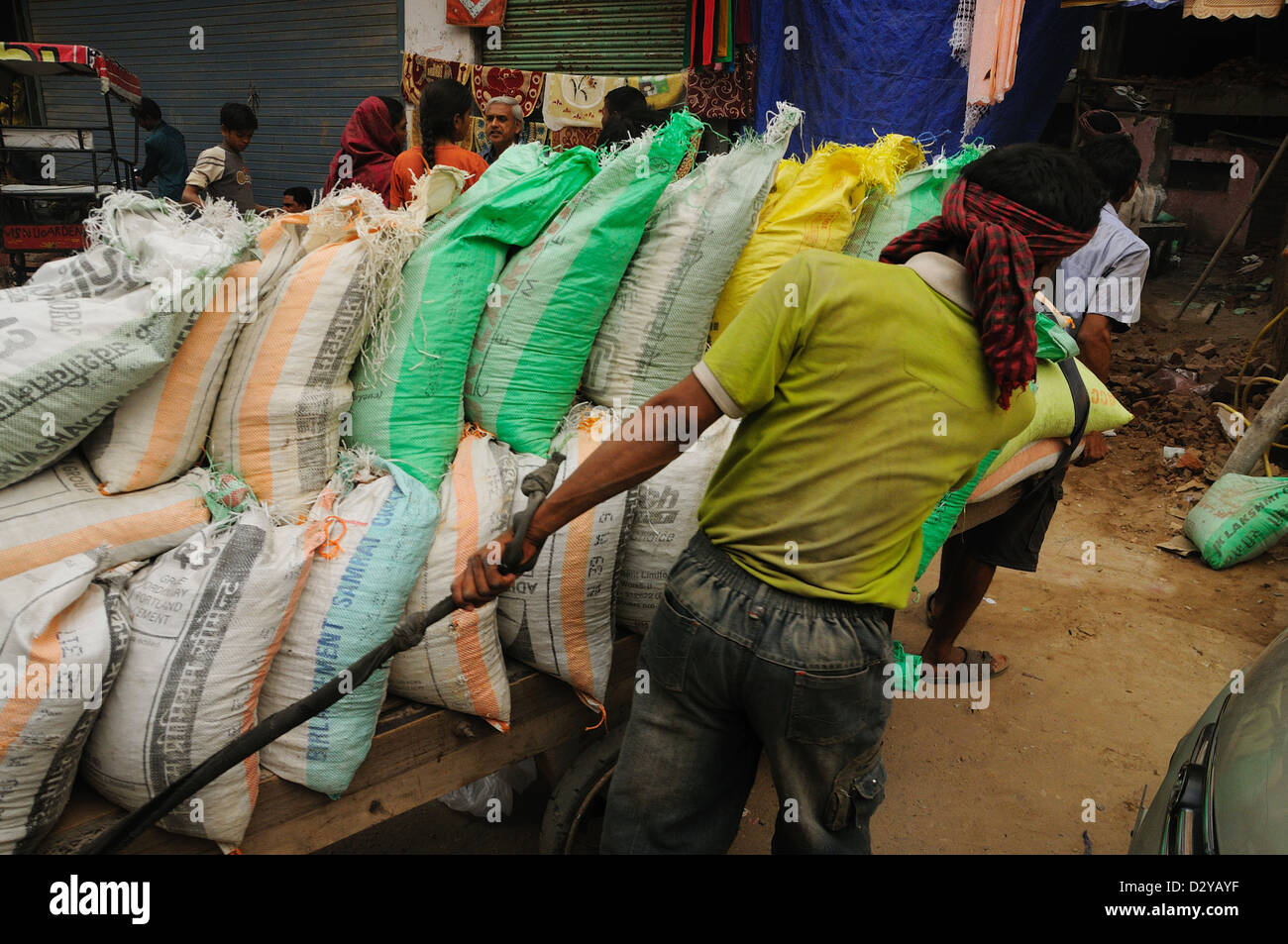 Construction worker carrying sand bag at New Delhi Stock Photo - Alamy